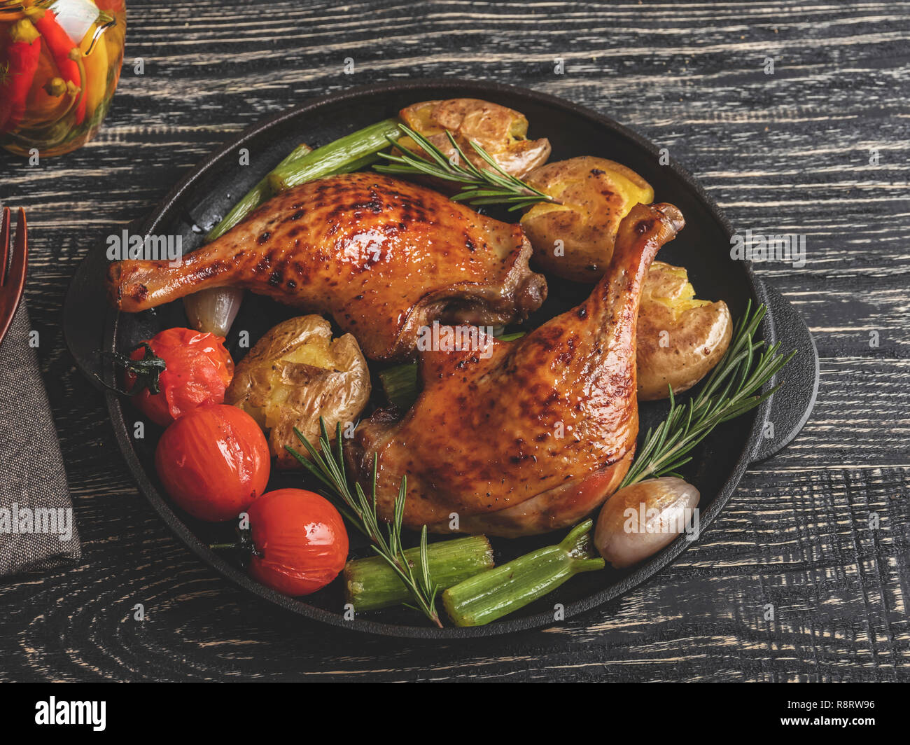 Grilled duck legs with vegetables in a pan Stock Photo - Alamy