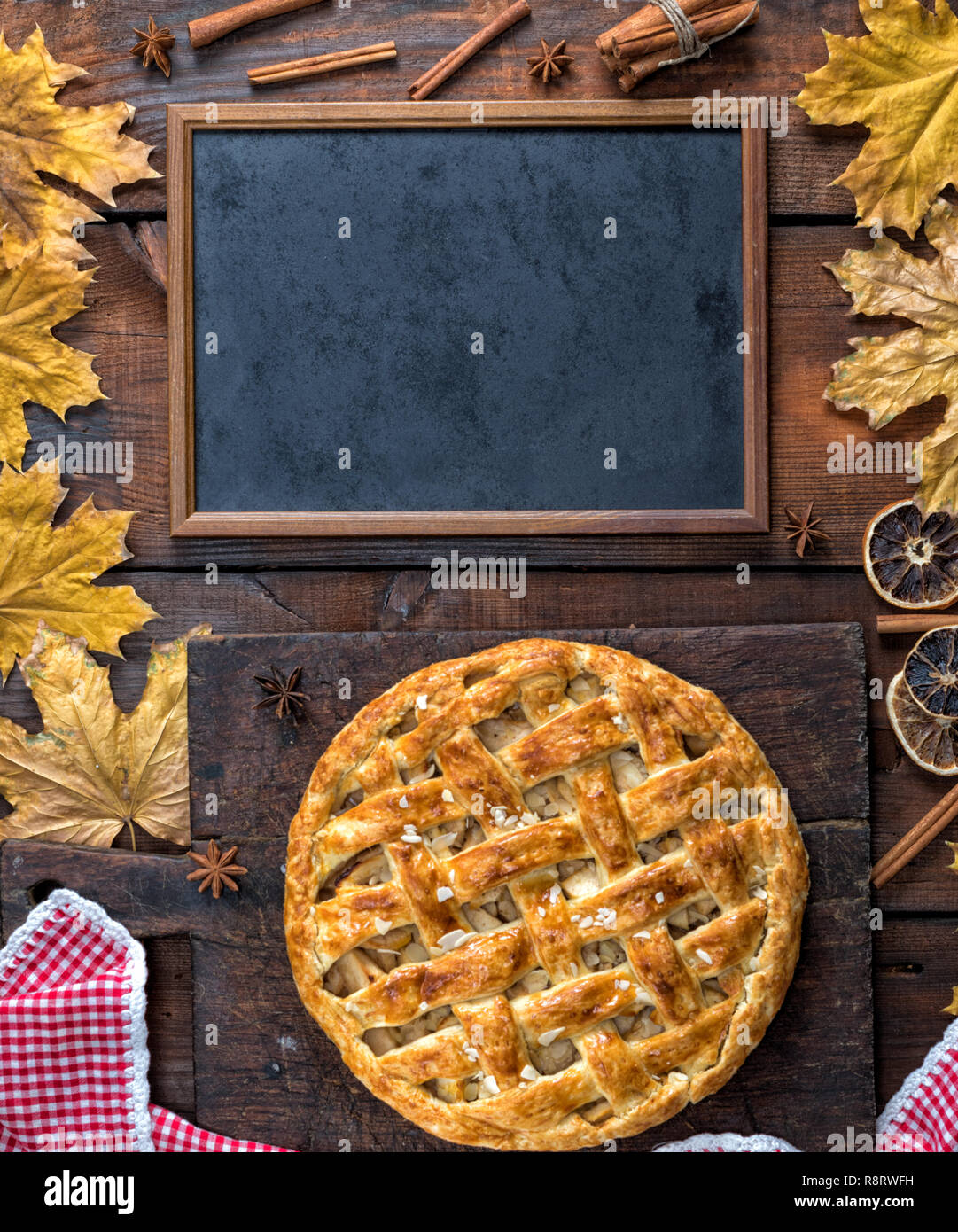 empty black chalk board and baked whole fruit cake on brown wooden ...