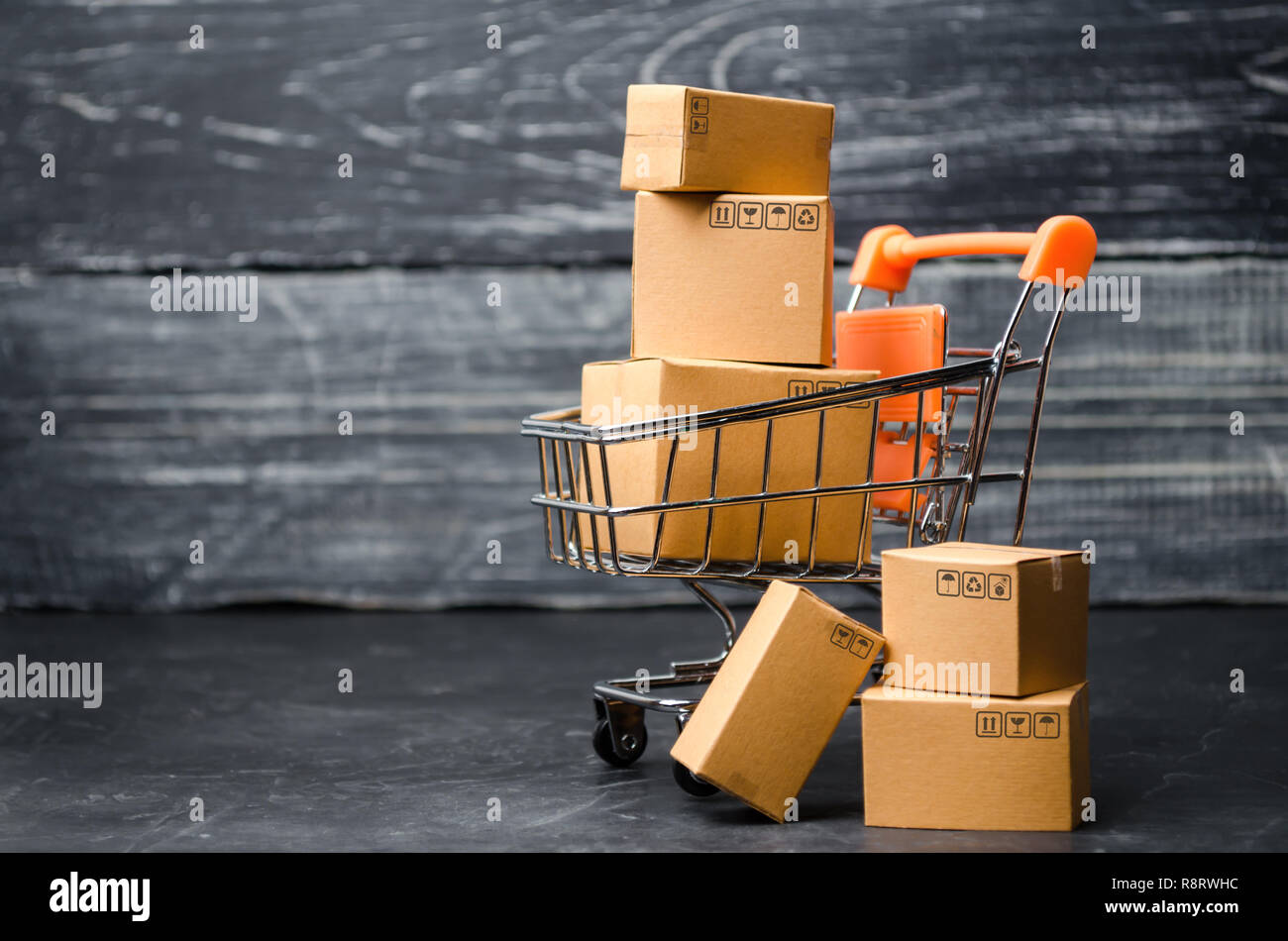 A supermarket cart loaded with cardboard boxes. Sales of goods. concept ...