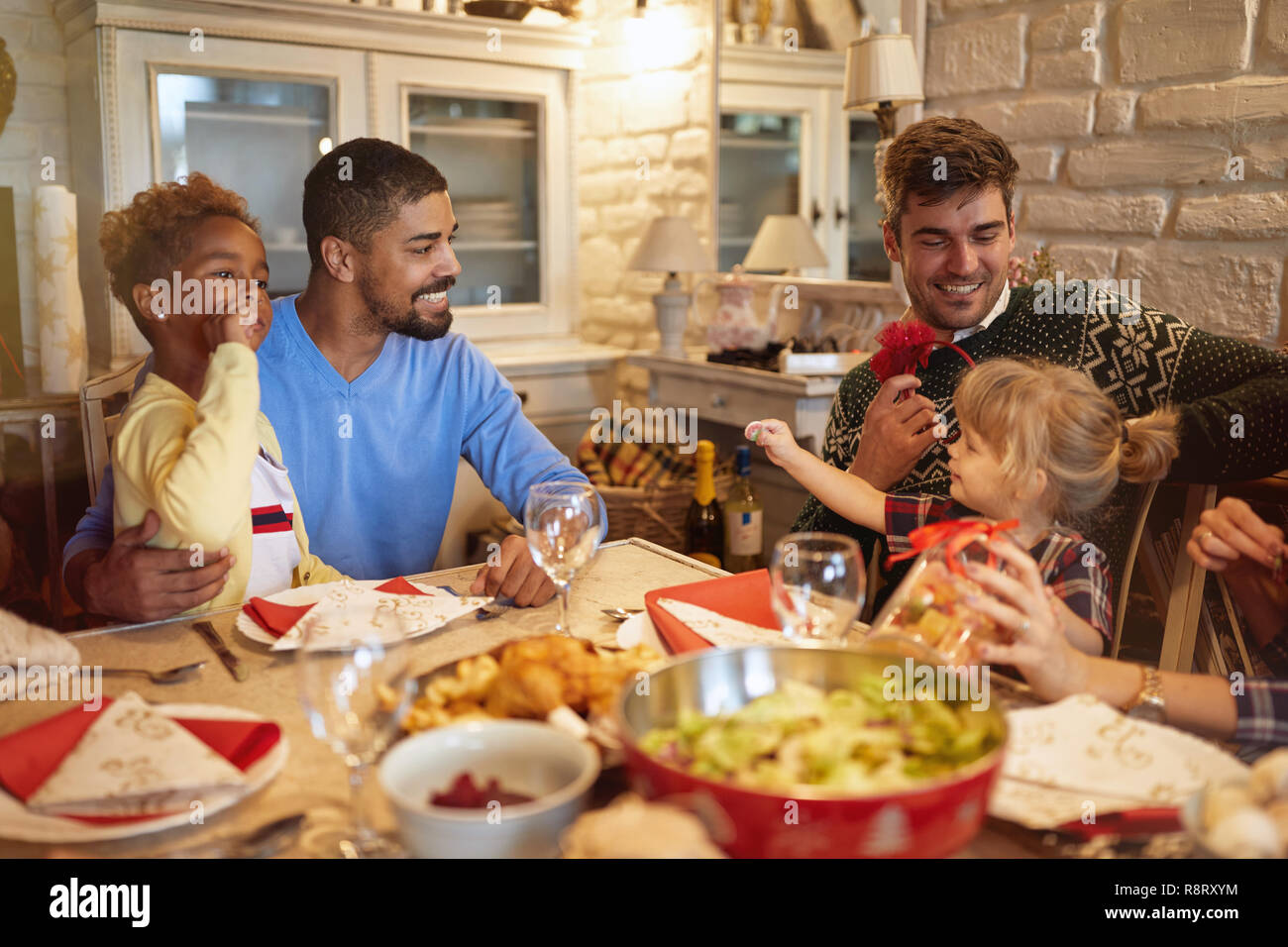 Family x-mas dinner - daddy with sweet daughters enjoy Christmas dinner ...