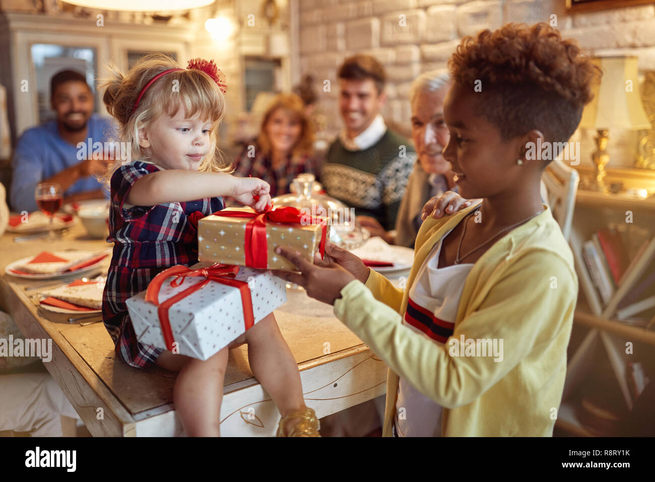 beautiful girls celebration holiday and giving Christmas present Stock ...