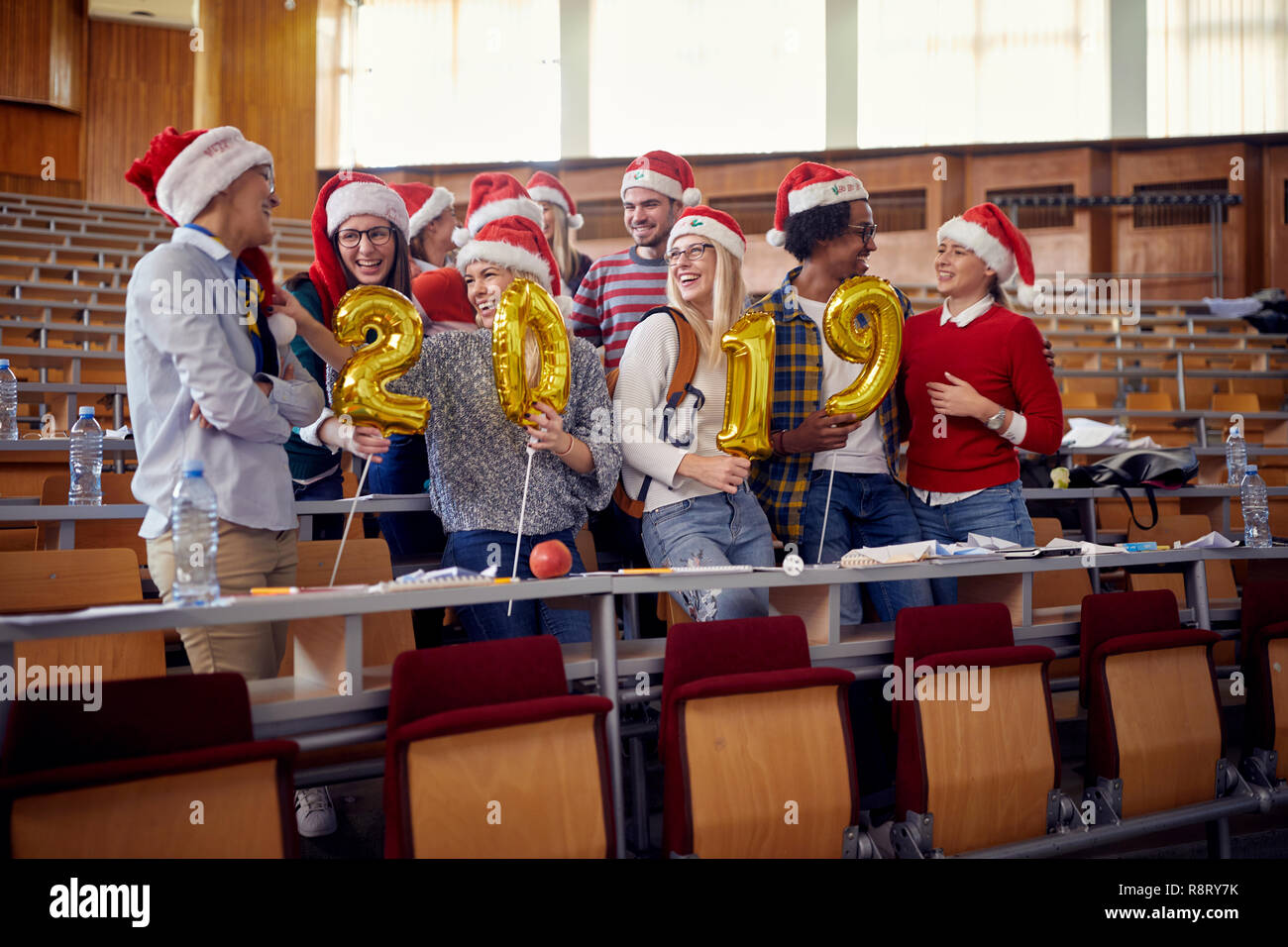 Happy Students friends in Santa hat holding 2019 golden balloons at New ...