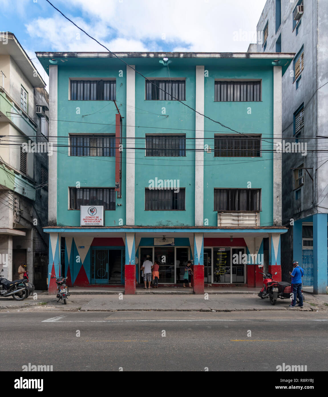 Colorful Cuban building painted a turquoise color with the pillars ...