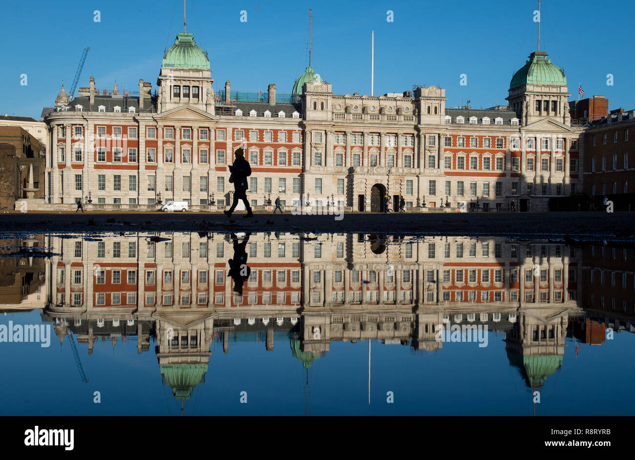 Admiralty House is seen reflected in a puddle on Horse Guards Parade ...