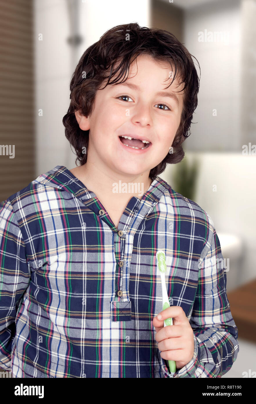 Funny child without some teeth brushing his teeth in the bathroom Stock ...