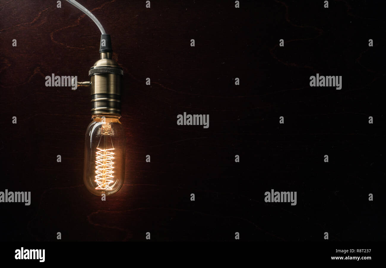 The light bulb illuminates on wooden background Stock Photo - Alamy