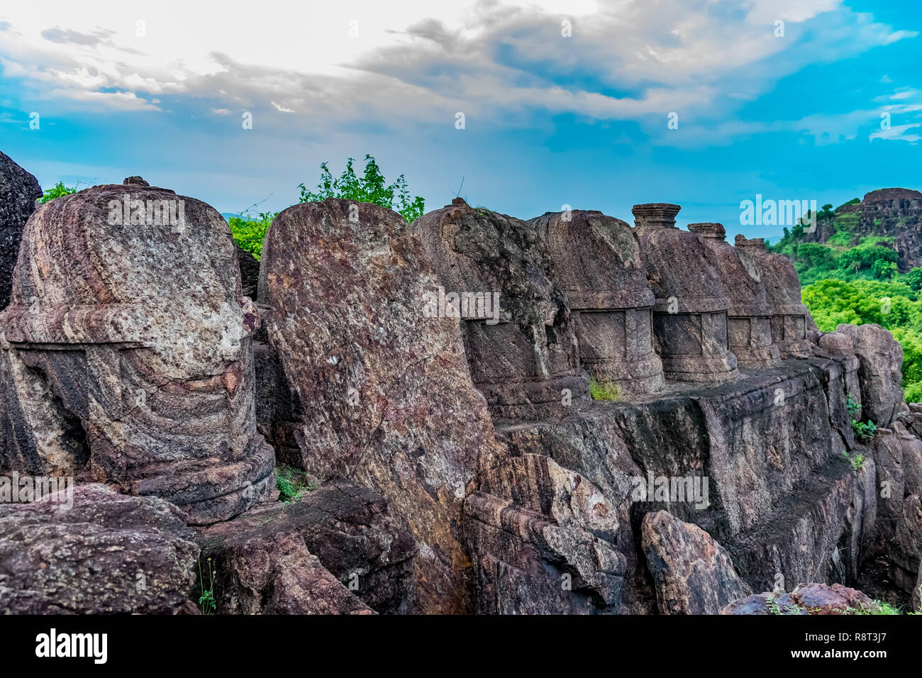 big circular rock shaped vertical located close top front & side view ...