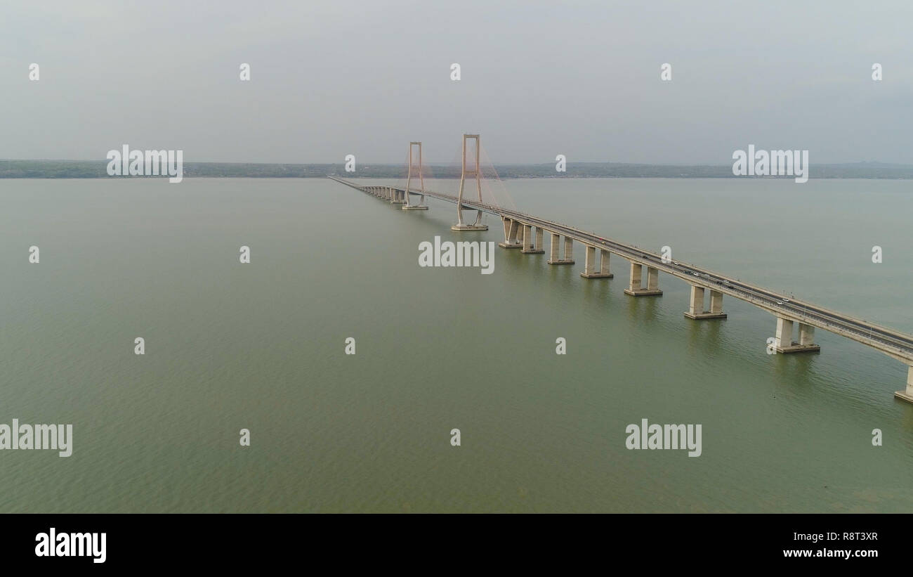 suspension bridge over madura strait with highway and car, surabaya ...