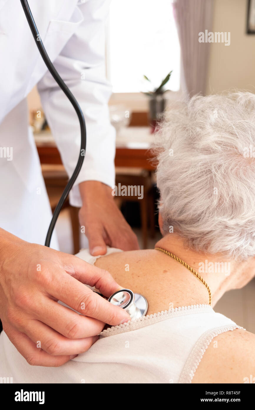 Doctor auscultating patient by stethoscope hi-res stock photography and ...