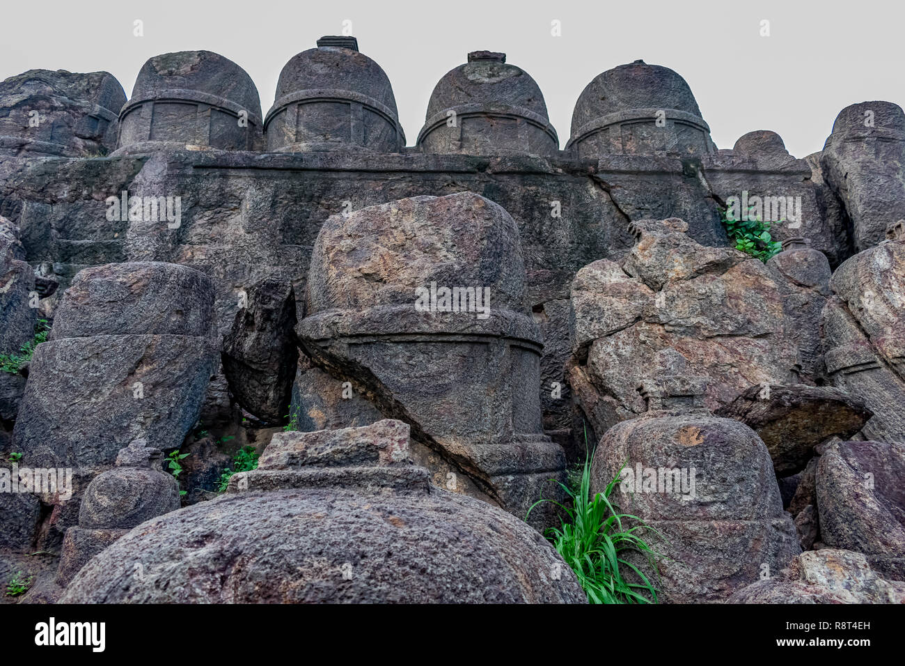 big circular rock shaped vertical located close top front & side view ...