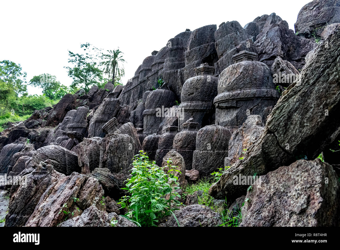 big circular rock shaped vertical located close top front & side view ...