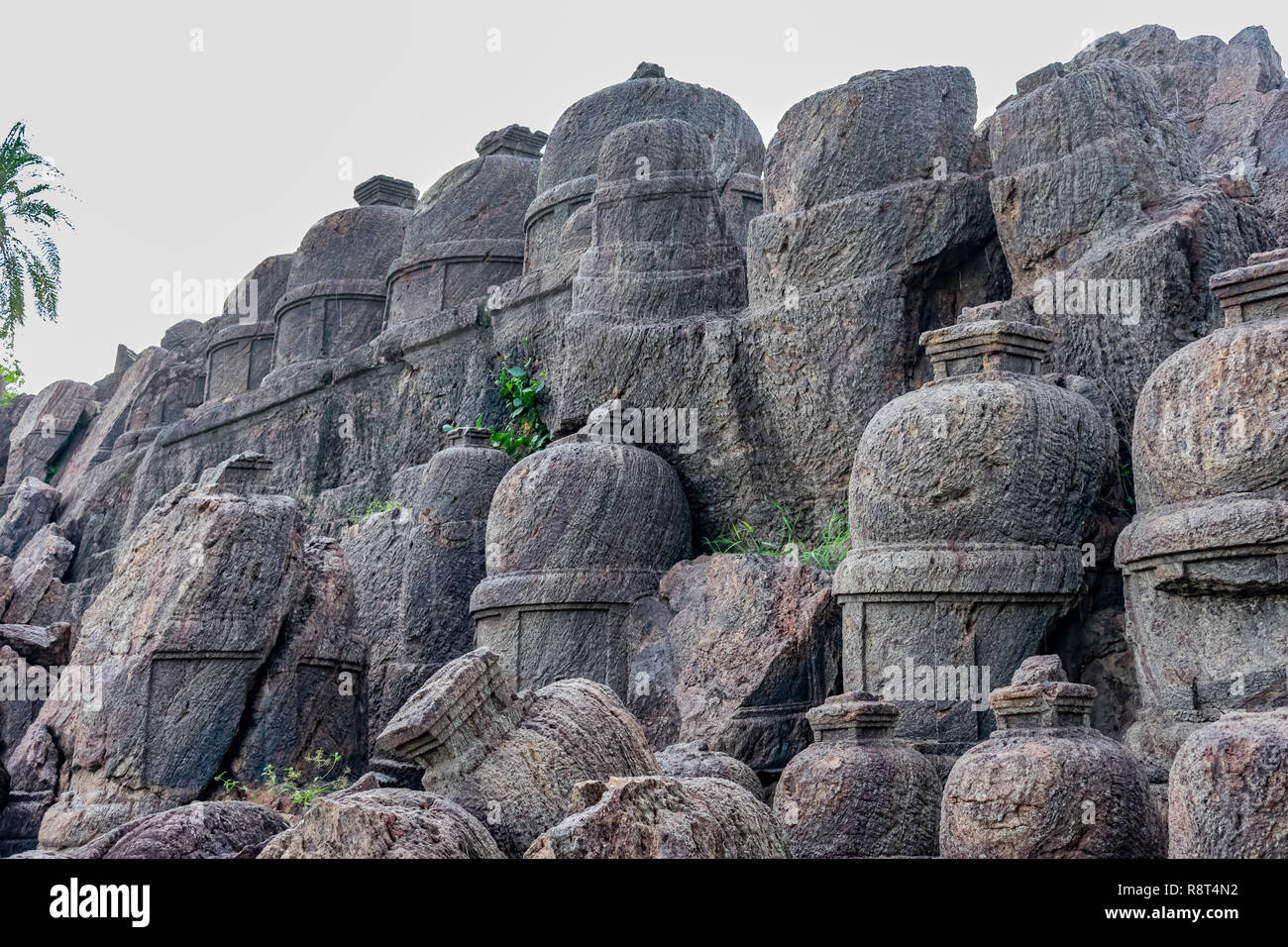 big circular rock shaped vertical located close top front & side view ...