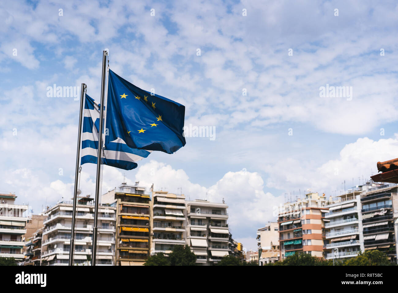 Flags of Greece and the European Union are developing on flagpoles ...