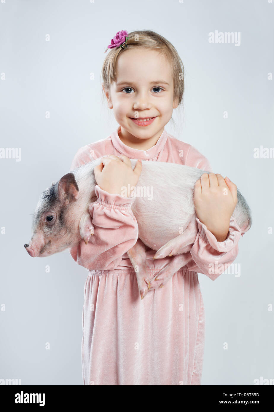 Smiling child girl and pig. Happy child in pink dress and pet Stock ...