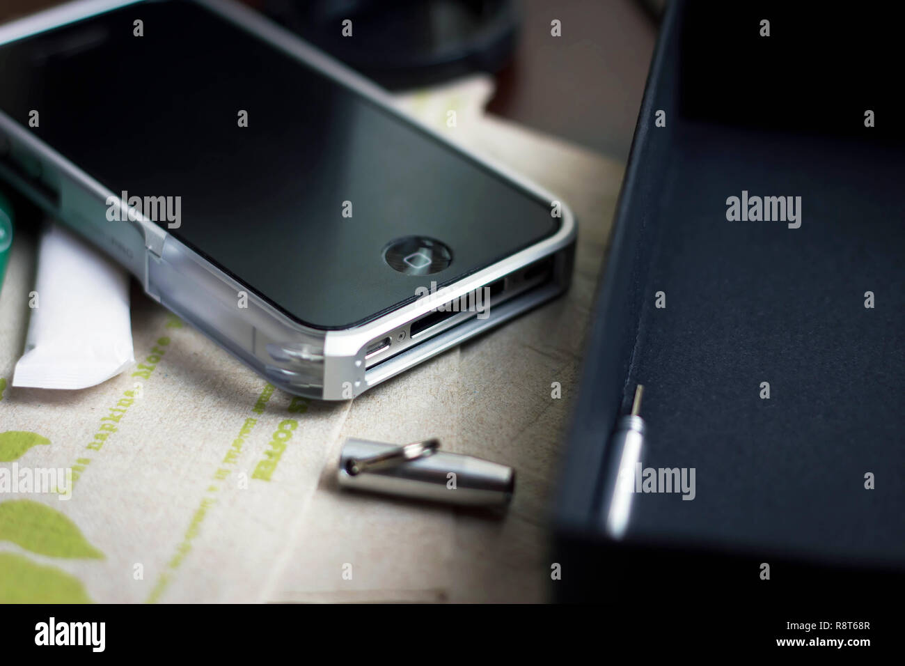 sophisticated and elegant mobile phone is silver being placed next to ...