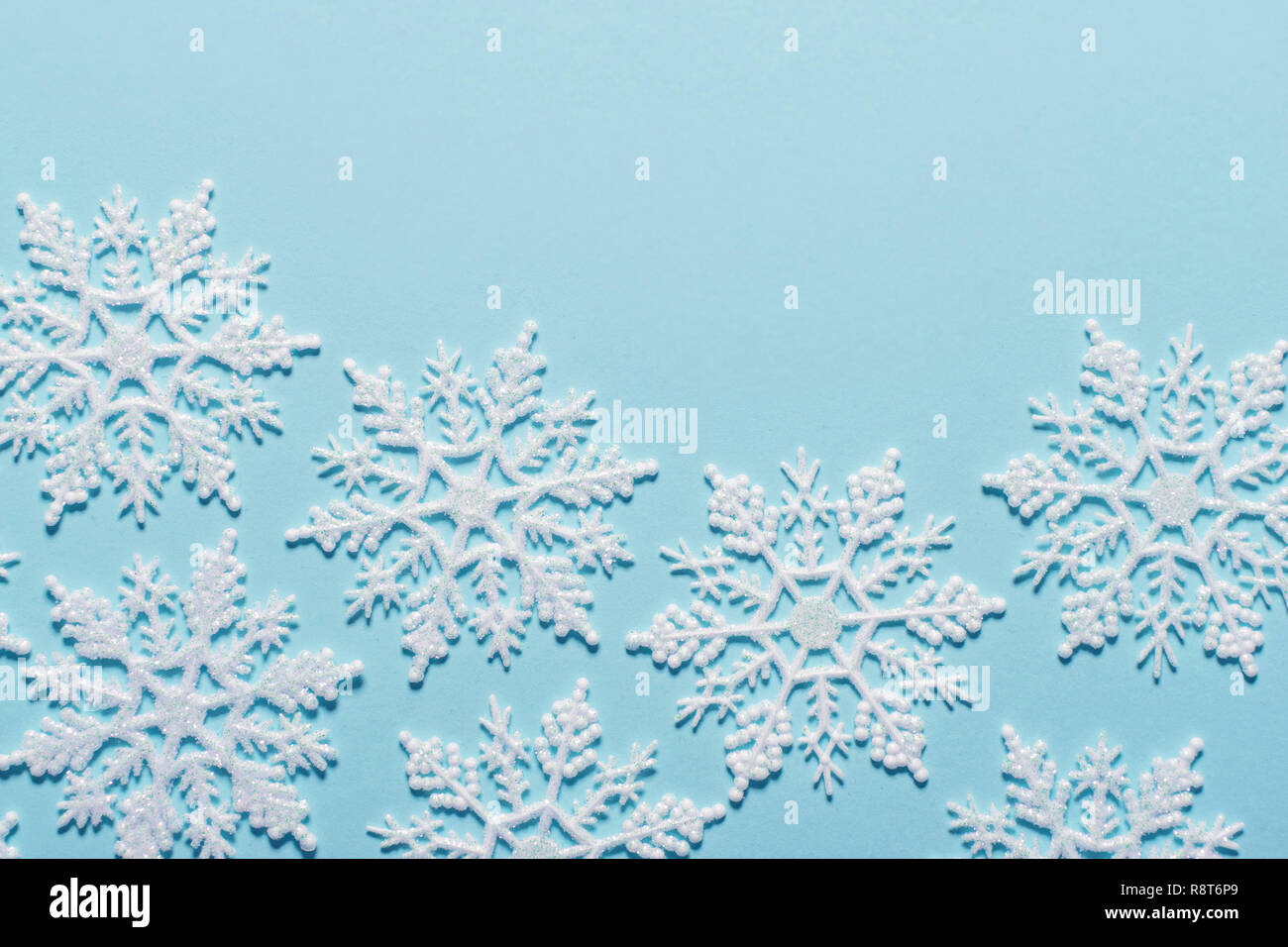 White glitter snowflake composition on a pastel blue background Stock ...