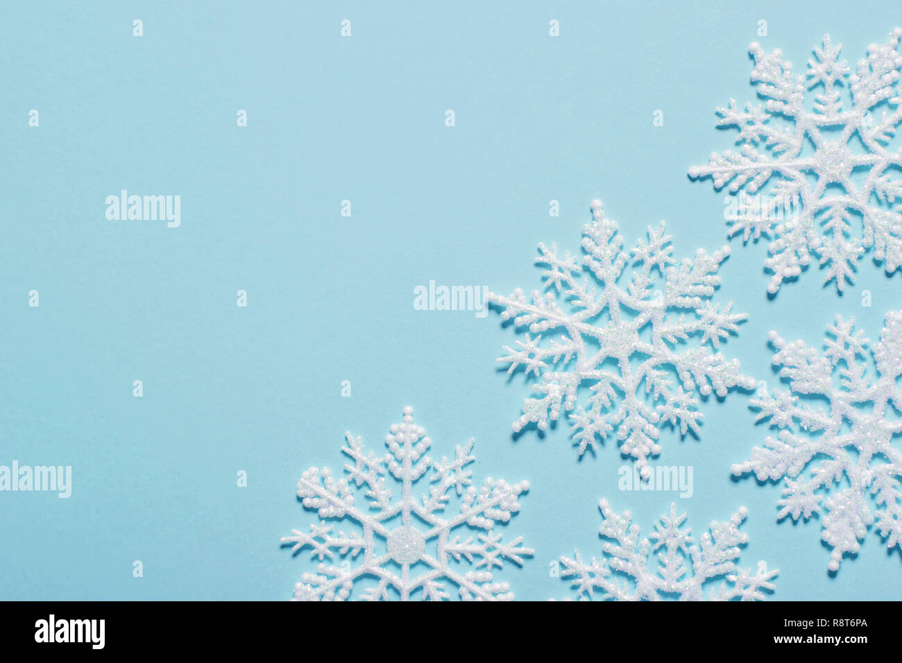 White glitter snowflake composition on a pastel blue background Stock ...