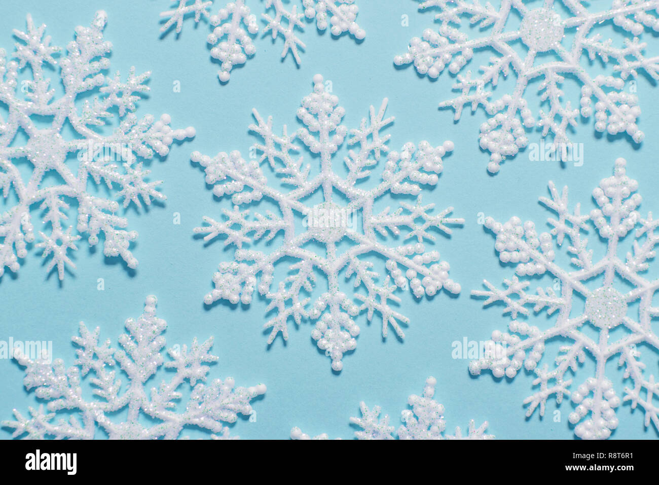 White glitter snowflake composition on a pastel blue background Stock ...