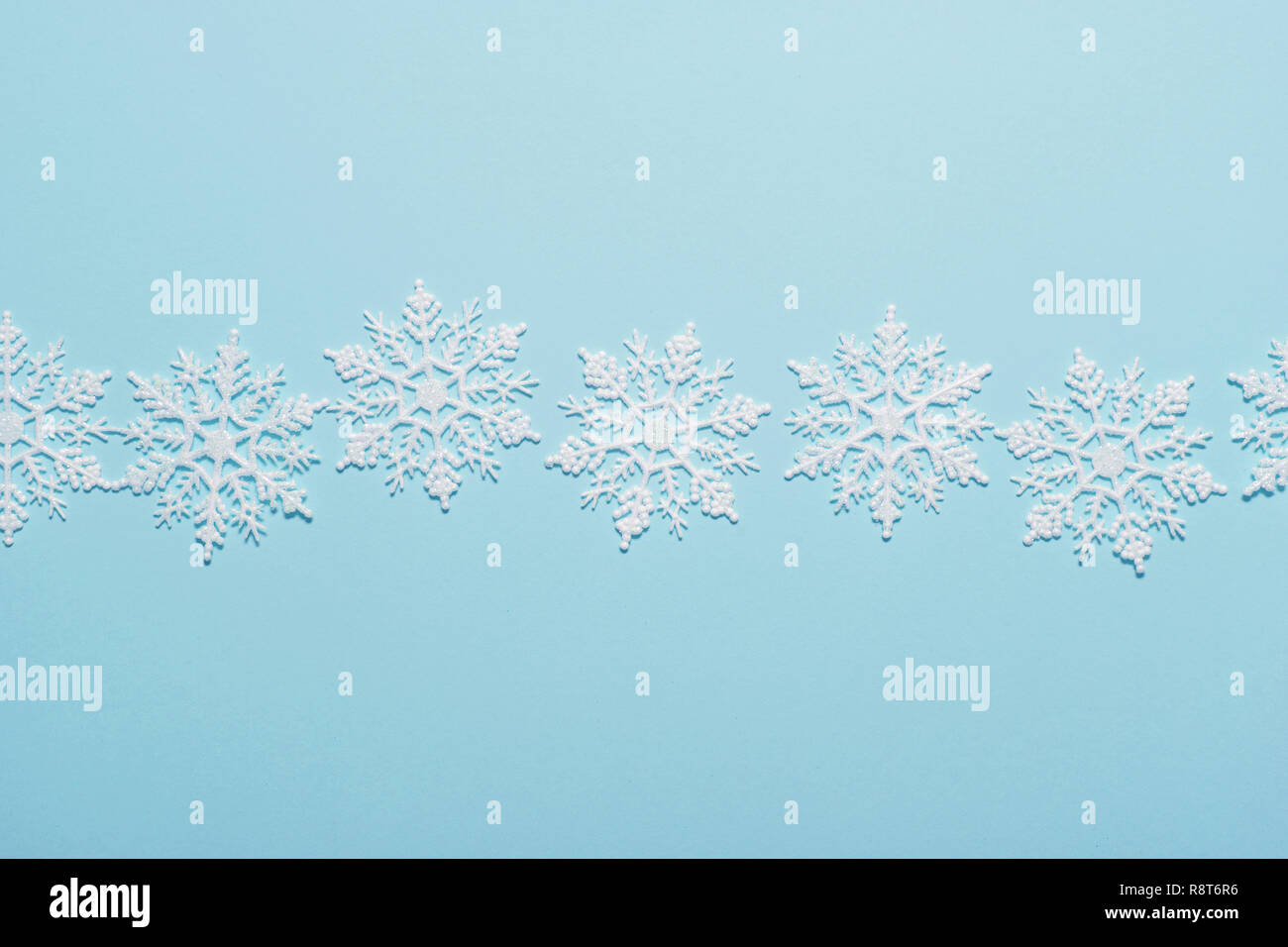 White glitter snowflake composition on a pastel blue background Stock ...