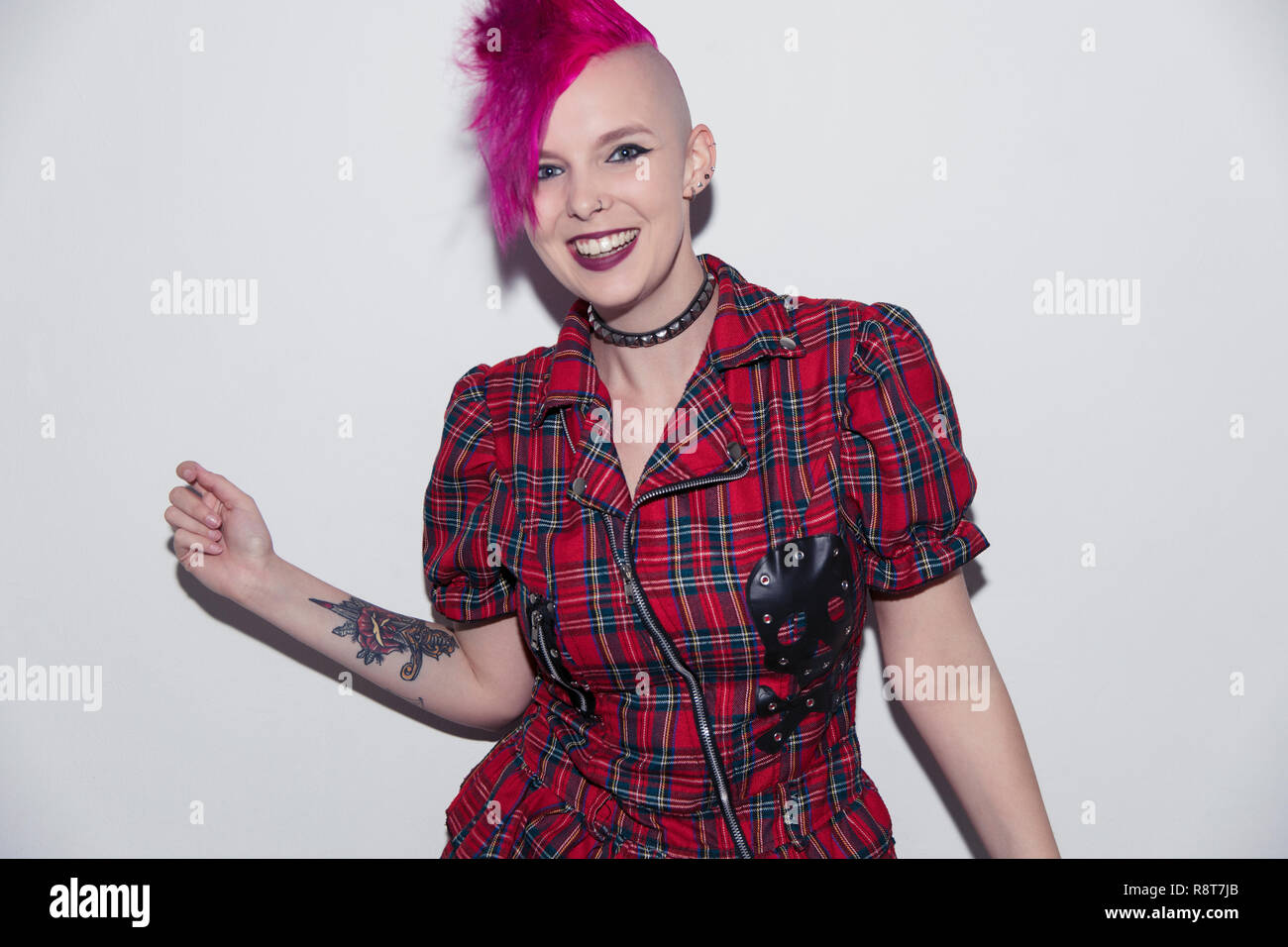 Portrait smiling, confident young woman with pink mohawk Stock Photo ...