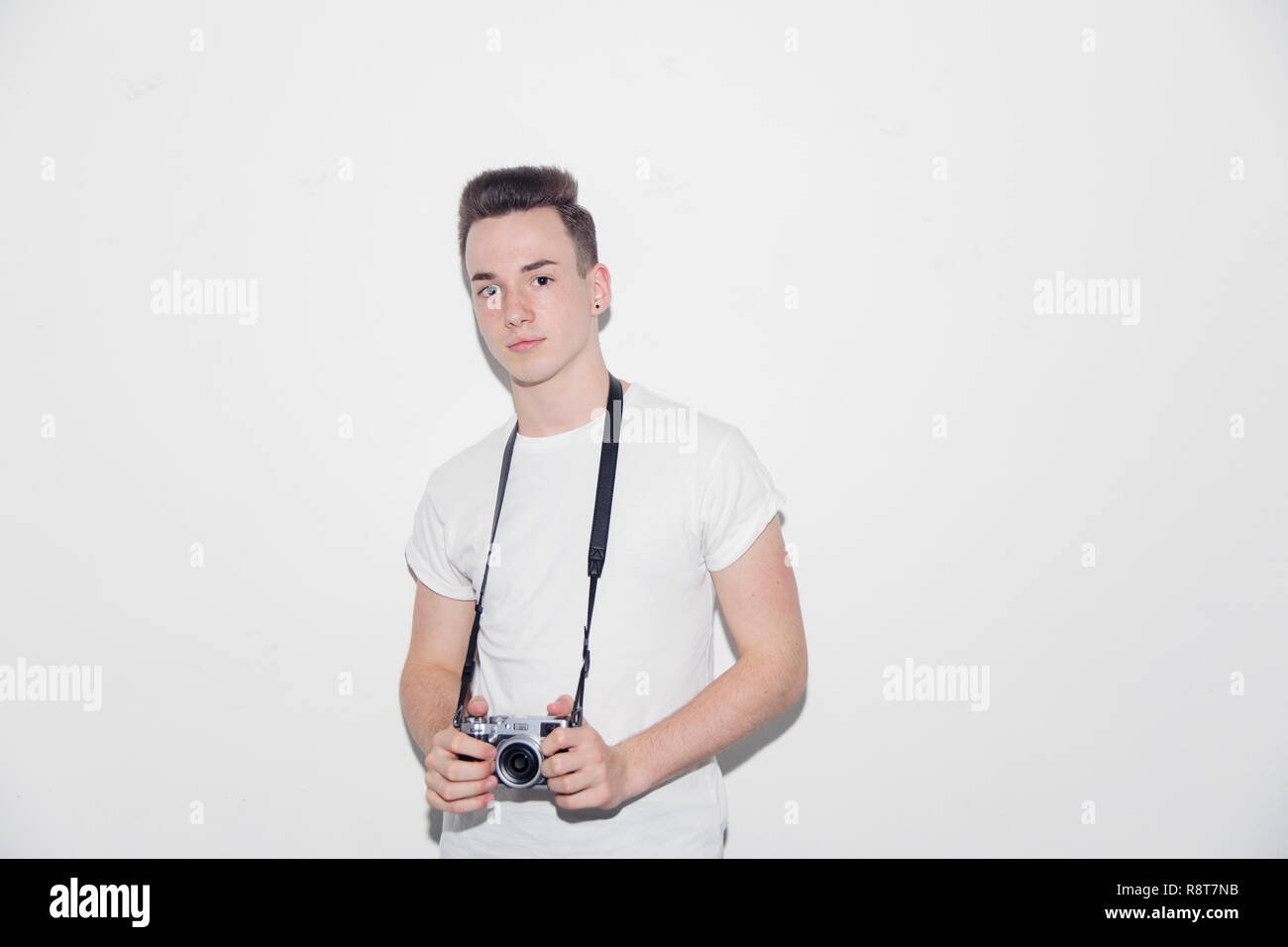 Portrait confident, cool teenage boy holding retro camera Stock Photo ... Portrait confident, cool teenage boy holding retro camera Stock Photo ...