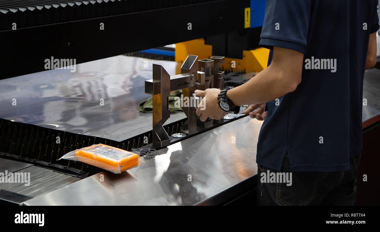 Worker operate CNC laser cutting machine cutting tube Stock Photo - Alamy