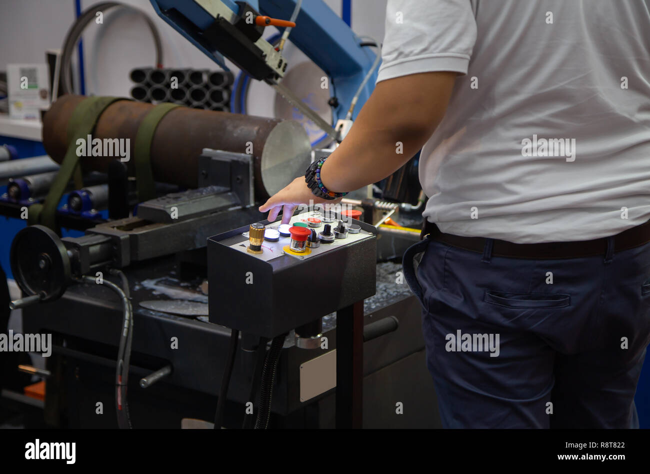Worker operate band saw machine cutting metal workpiece Stock Photo - Alamy
