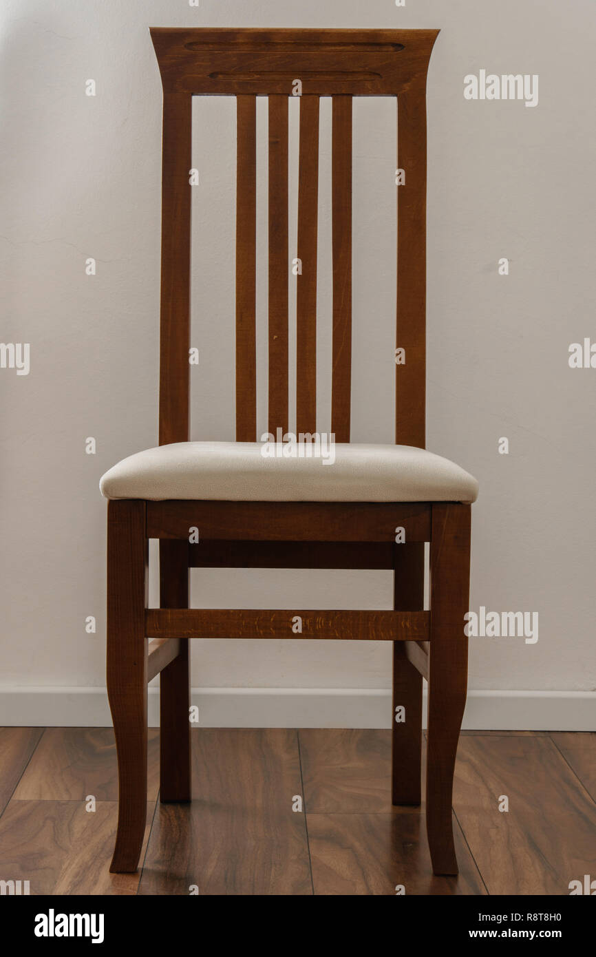 One isolated wooden chair in an empty living room Stock Photo - Alamy