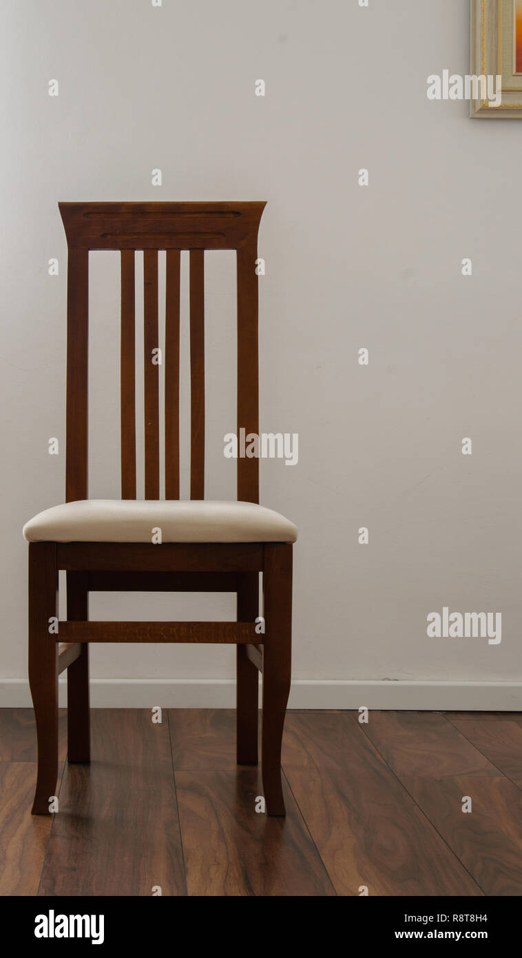 One isolated wooden chair in an empty living room Stock Photo - Alamy