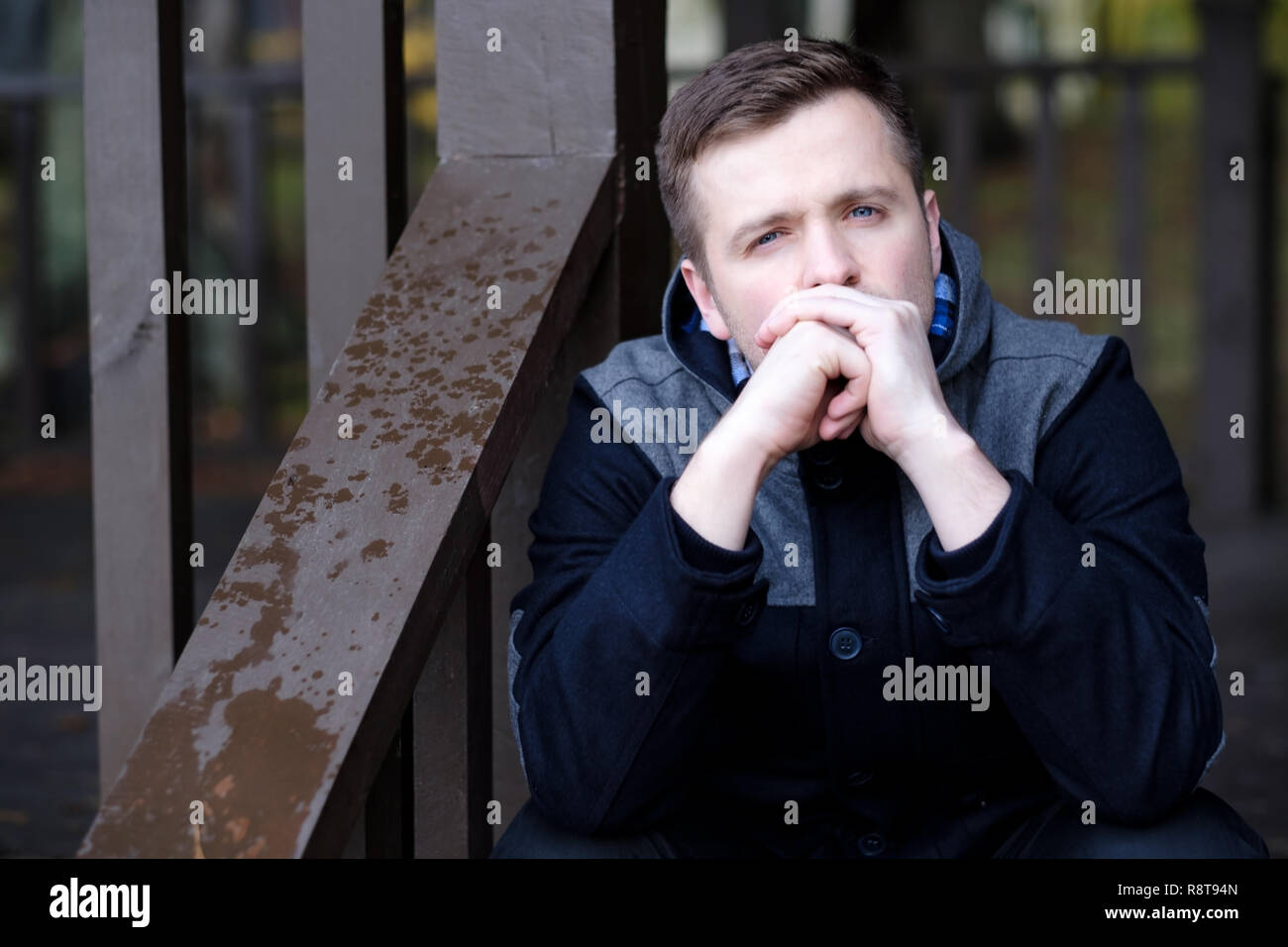 Desperate european man sitting alone on stairs outdoors in autumn. He ...