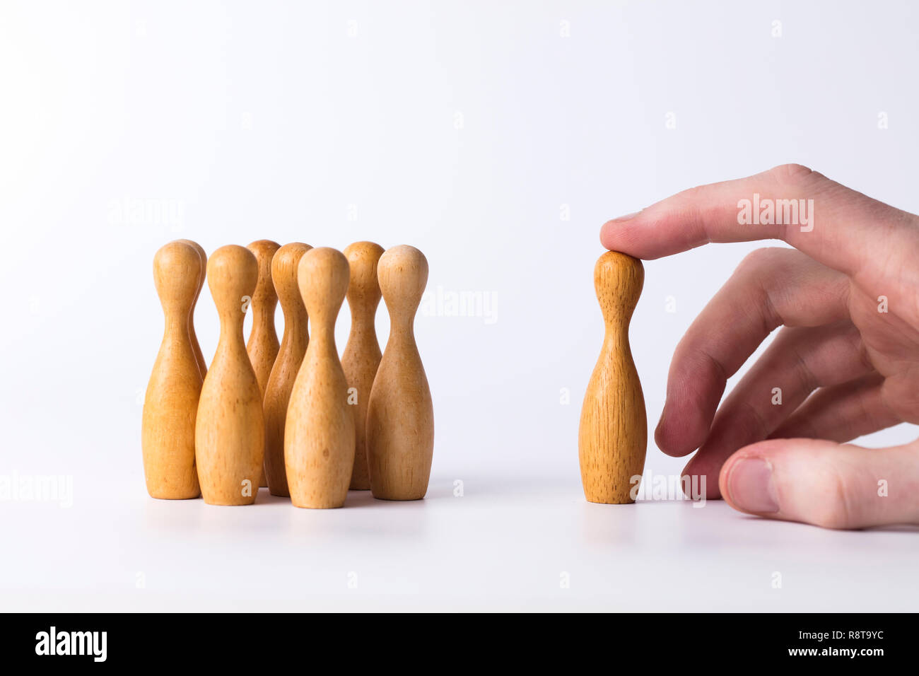 Hand selecting a wooden figure. Business leadership concept Stock Photo ...