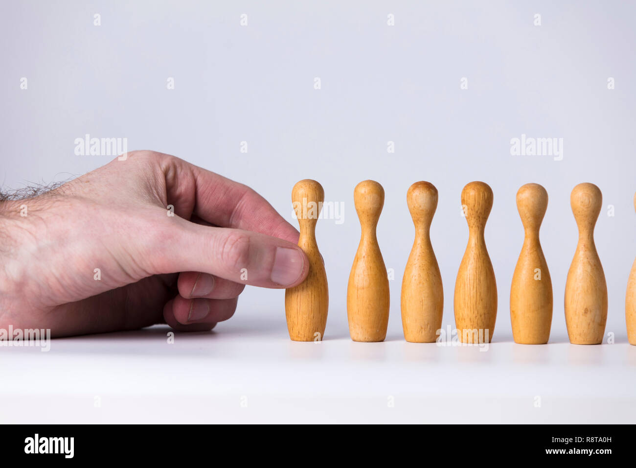Hand selecting a wooden figure. Business leadership concept Stock Photo ...