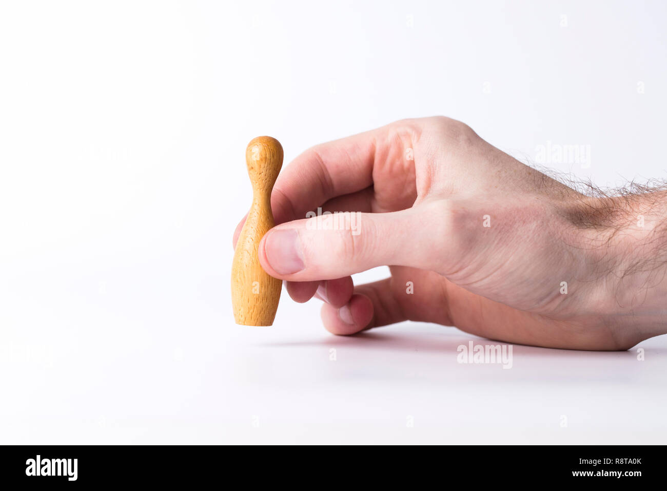 Hand selecting a wooden figure. Business leadership concept Stock Photo ...