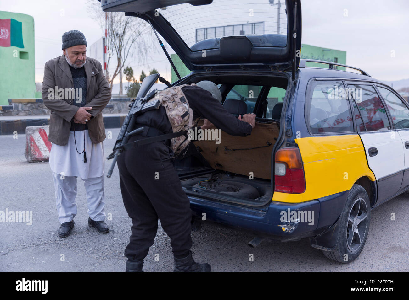 Afghanistan, Afghanistan. 18th Dec, 2018. An Afghan policeman searches ...