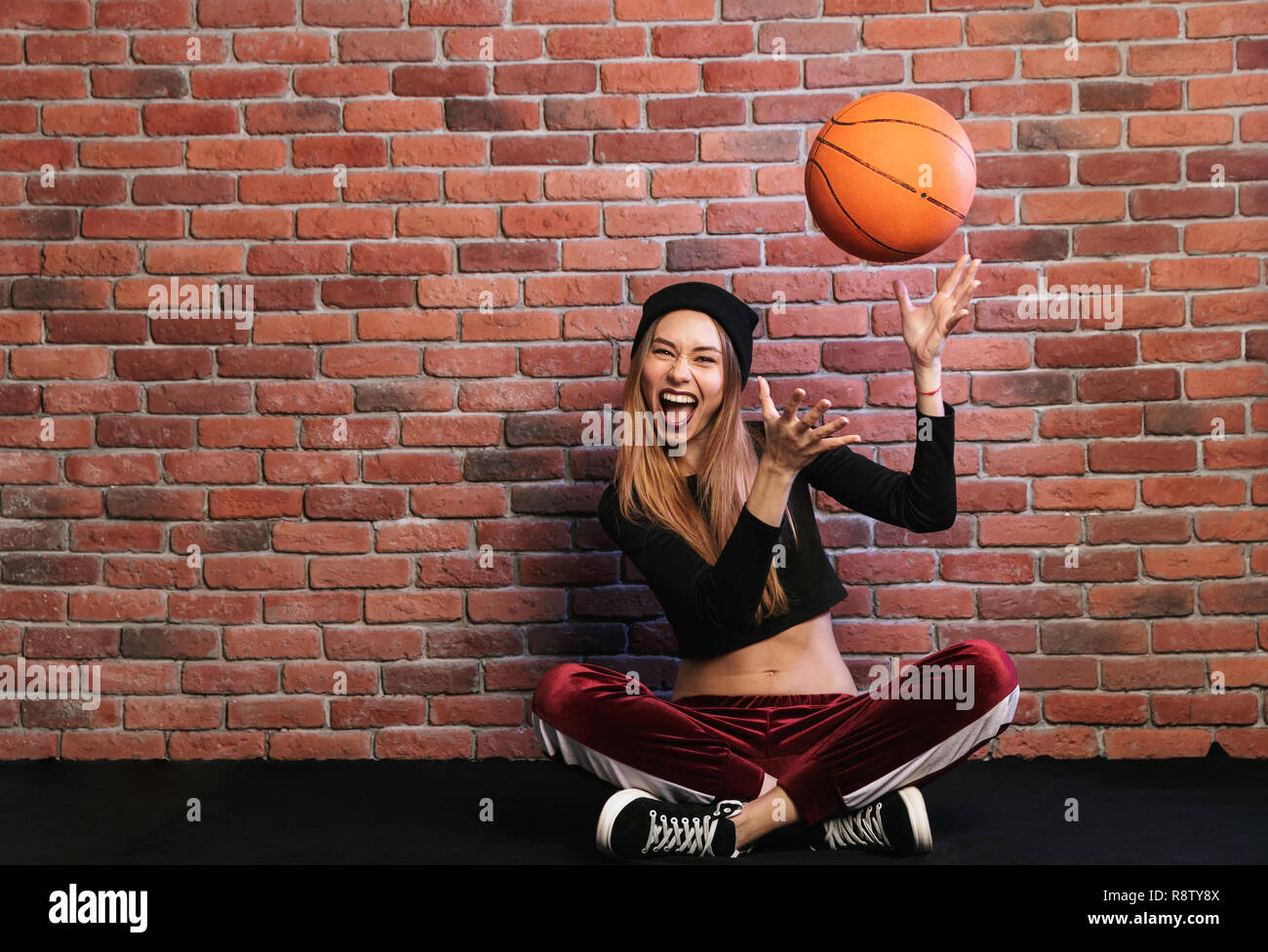 Girl sitting on basketball hi-res stock photography and images - Alamy