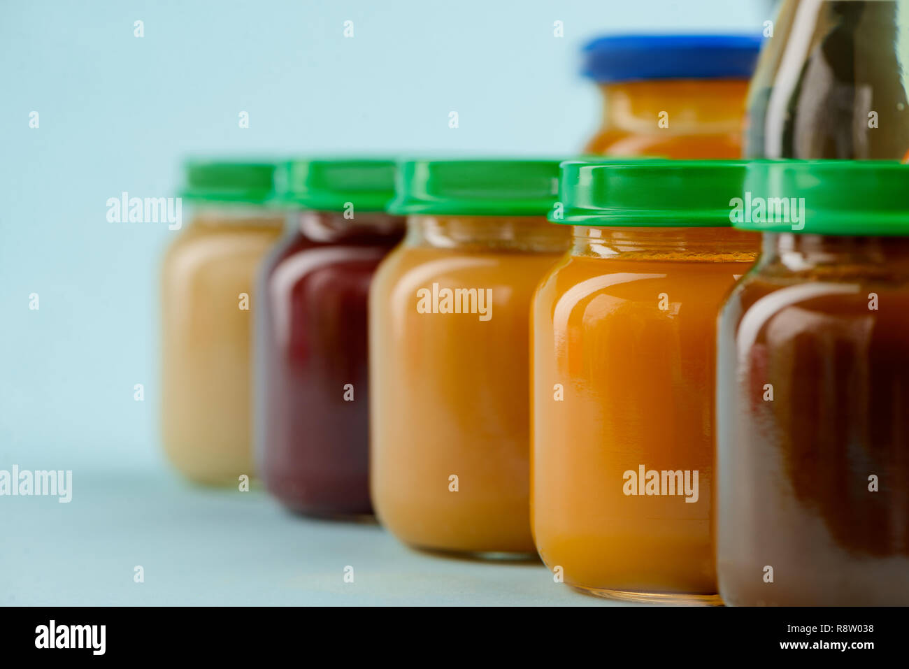 Jars of puree on blue Stock Photo - Alamy