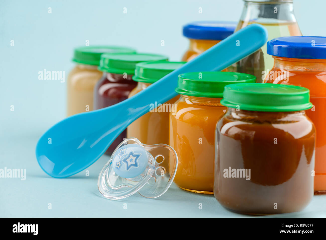 Baby food, spoon and pacifier Stock Photo - Alamy
