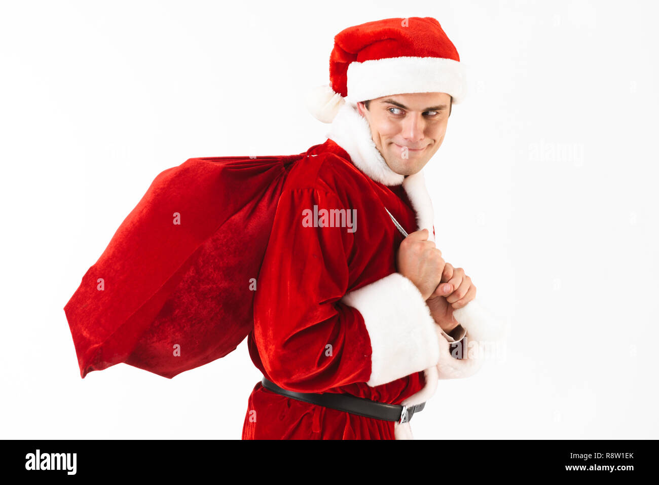 Portrait of tricky man 30s in santa claus costume and red hat walking ...
