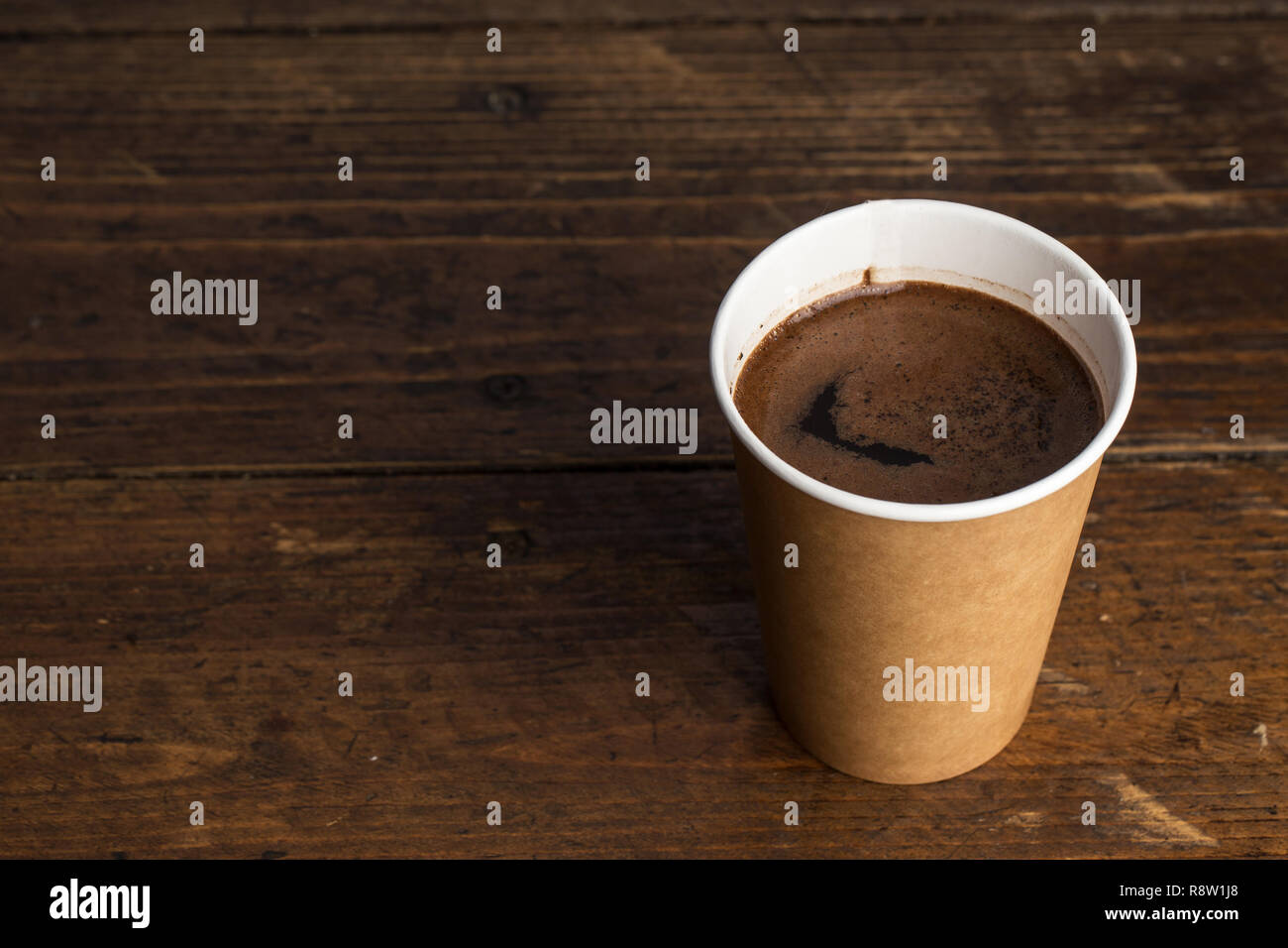 coffee to go in a disposable cup on a white background, space for text ...