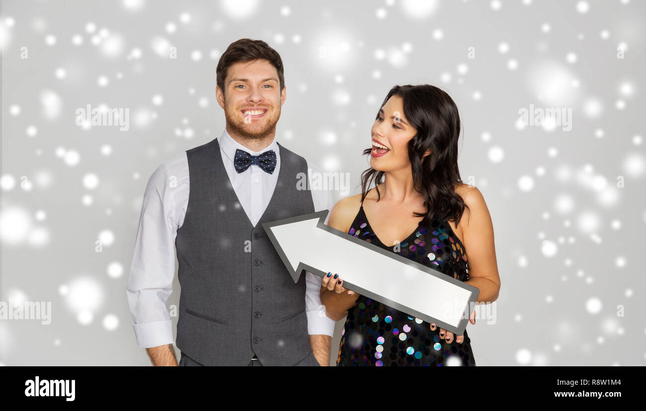 happy couple with big arrow at party Stock Photo - Alamy