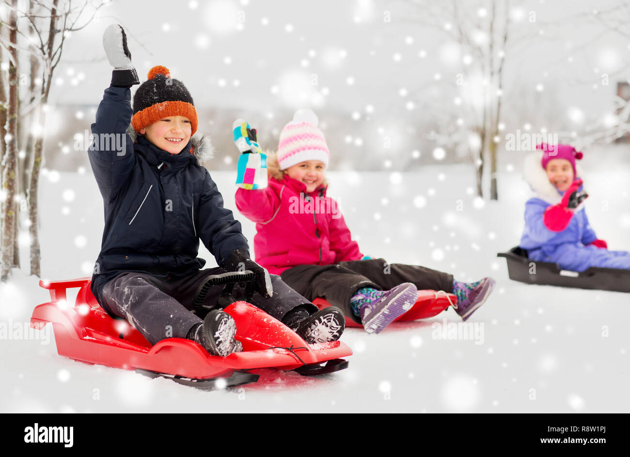 happy little kids sliding on sleds in winter Stock Photo - Alamy