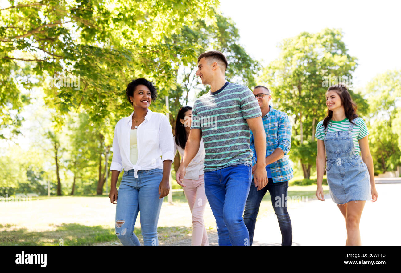 Multiracial friends walking together in hi-res stock photography and ...