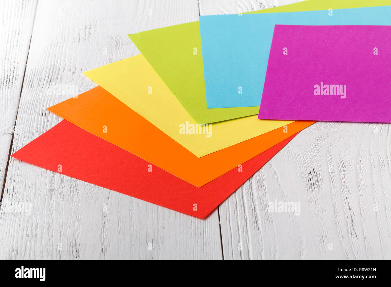 Designer desk with colored paper Stock Photo - Alamy