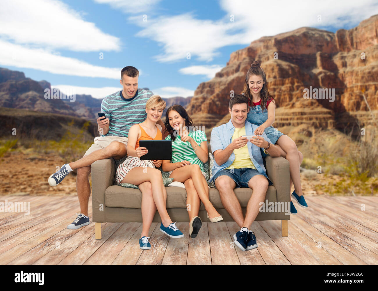 friends with modern gadgets over grand canyon Stock Photo - Alamy