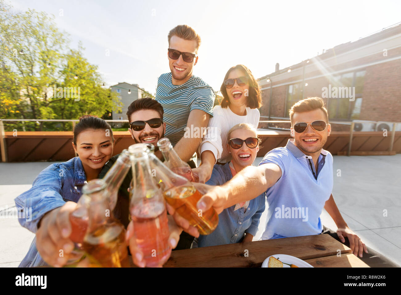 happy friends toasting drinks at rooftop party Stock Photo - Alamy