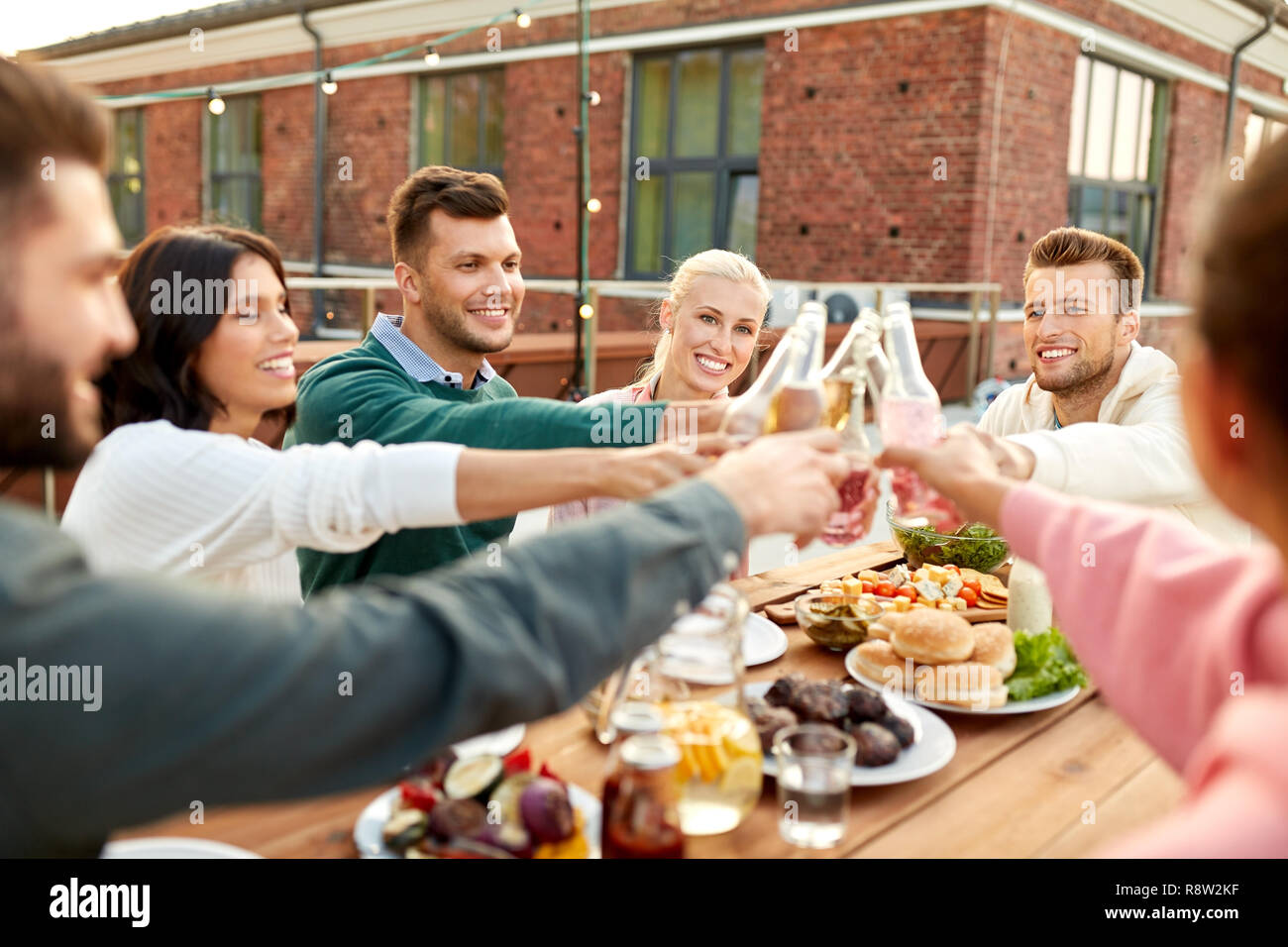 happy friends toasting drinks at rooftop party Stock Photo - Alamy