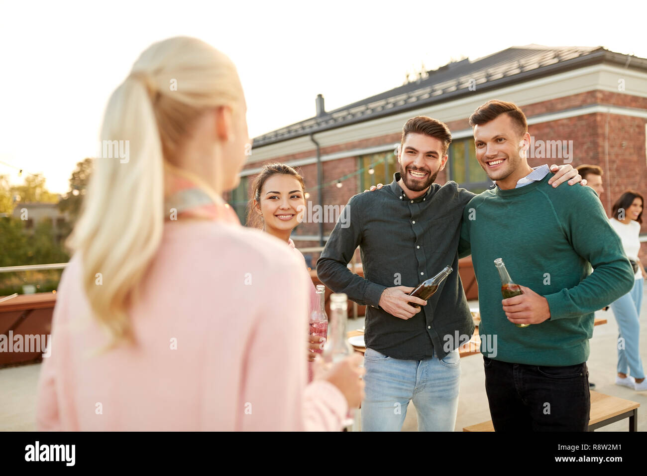 happy friends with drinks hugging at rooftop party Stock Photo - Alamy