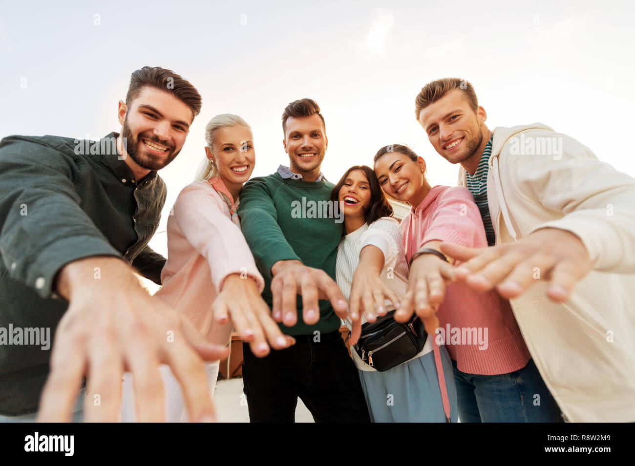 happy friends reaching hands to you Stock Photo - Alamy