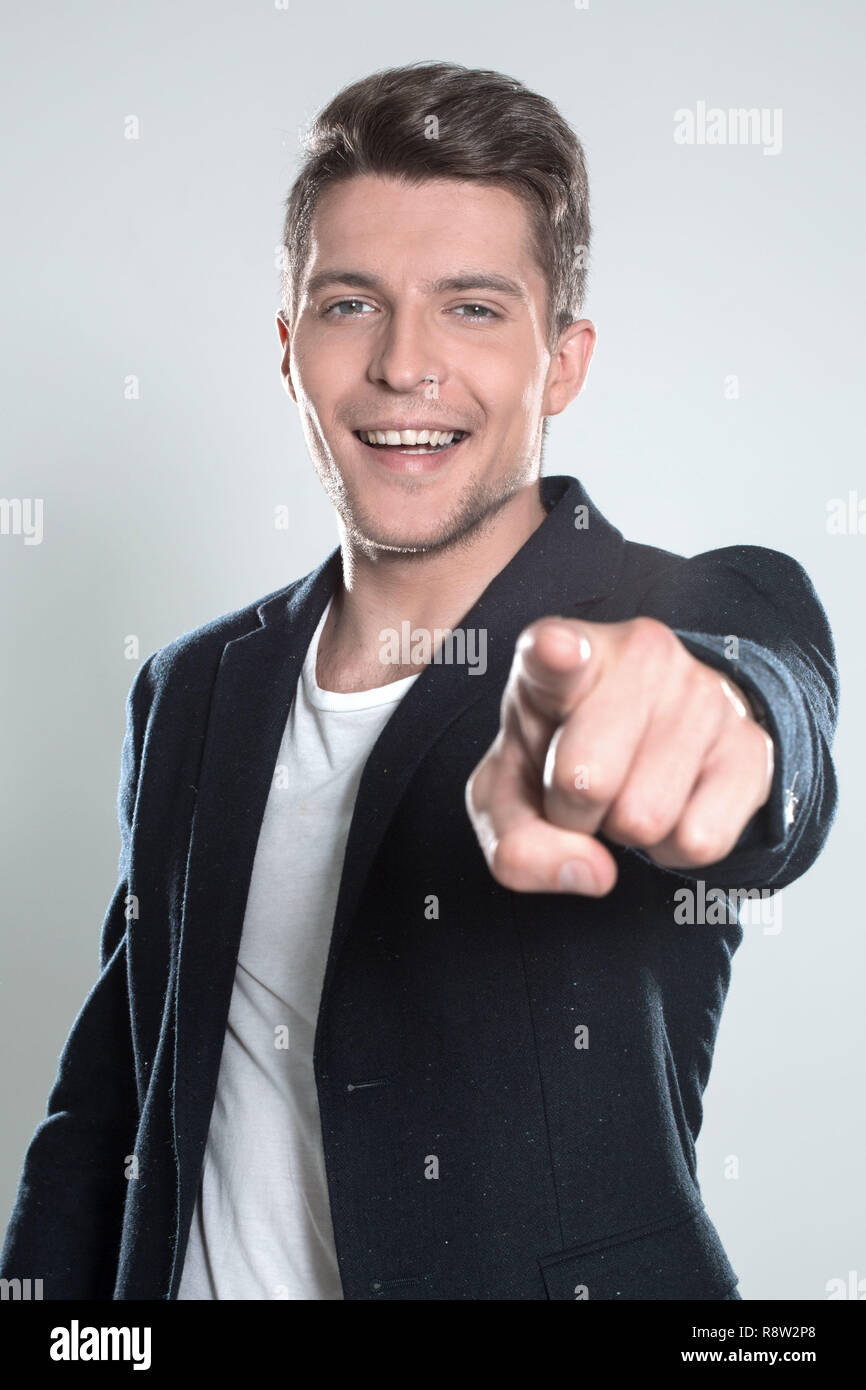 Business man pointing finger at you, isolated on gray Stock Photo - Alamy