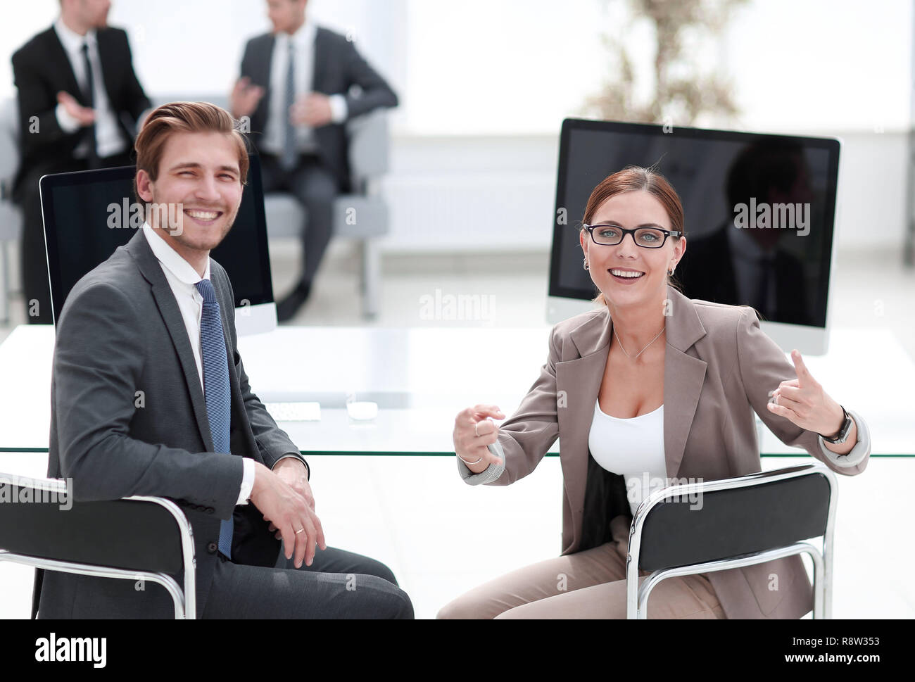 happy employees sitting at the office Desk Stock Photo - Alamy